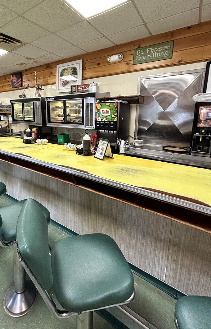 The counter seating offers front-row views of the kitchen magic, where breakfast orders fly out with practiced precision.