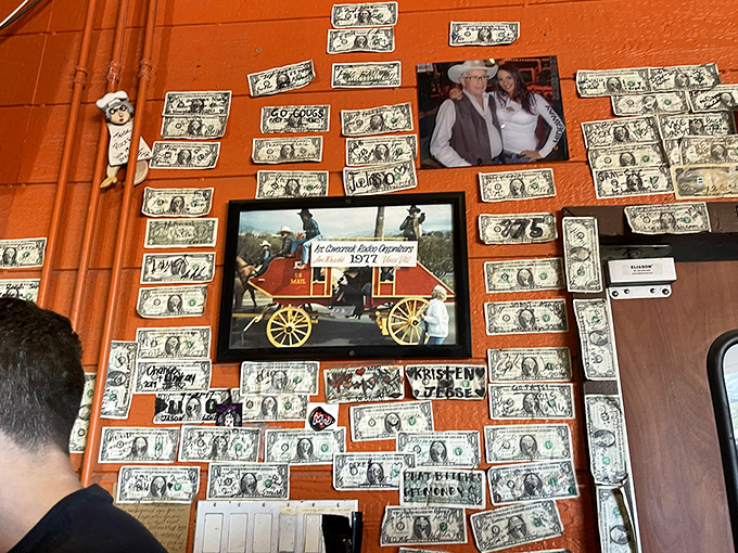 Dollar bills from satisfied customers paper the walls, creating a quirky financial tapestry that tells the story of visitors from near and far.