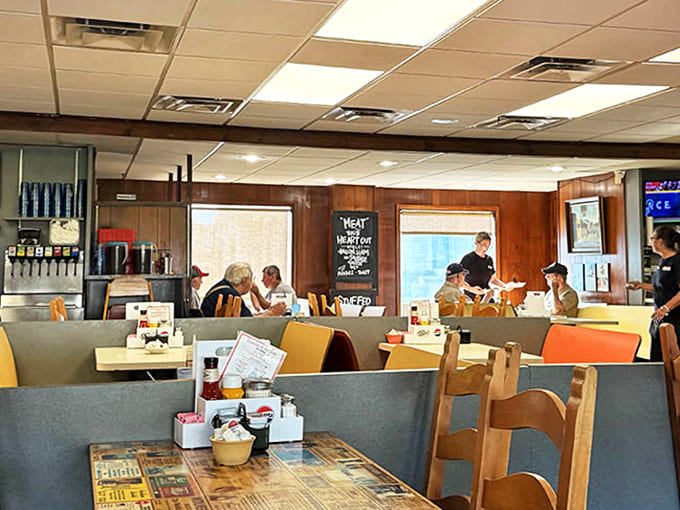 Visitors enjoy warm conversations surrounded by colorful bookshelves at Elements Books Coffee Beer, a cozy gathering spot in downtown Biddeford, Maine.
