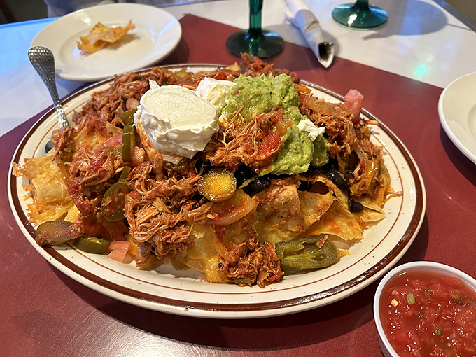 These loaded nachos aren't just an appetizer; they're a commitment to excellence &ndash; each chip maintaining structural integrity under its mountain of toppings.