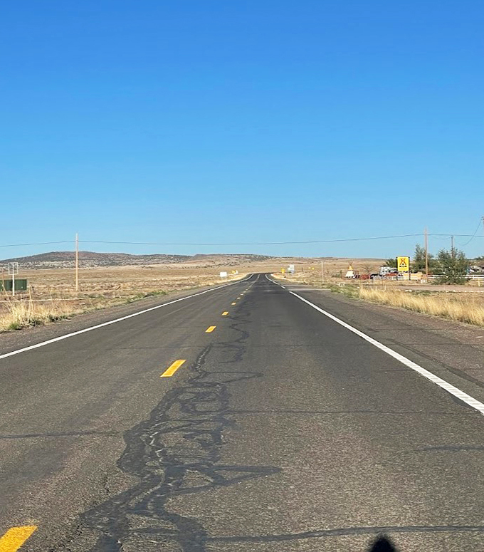 The open road beckons! This stretch of asphalt is your ticket to adventure, just add wheels and wanderlust.
