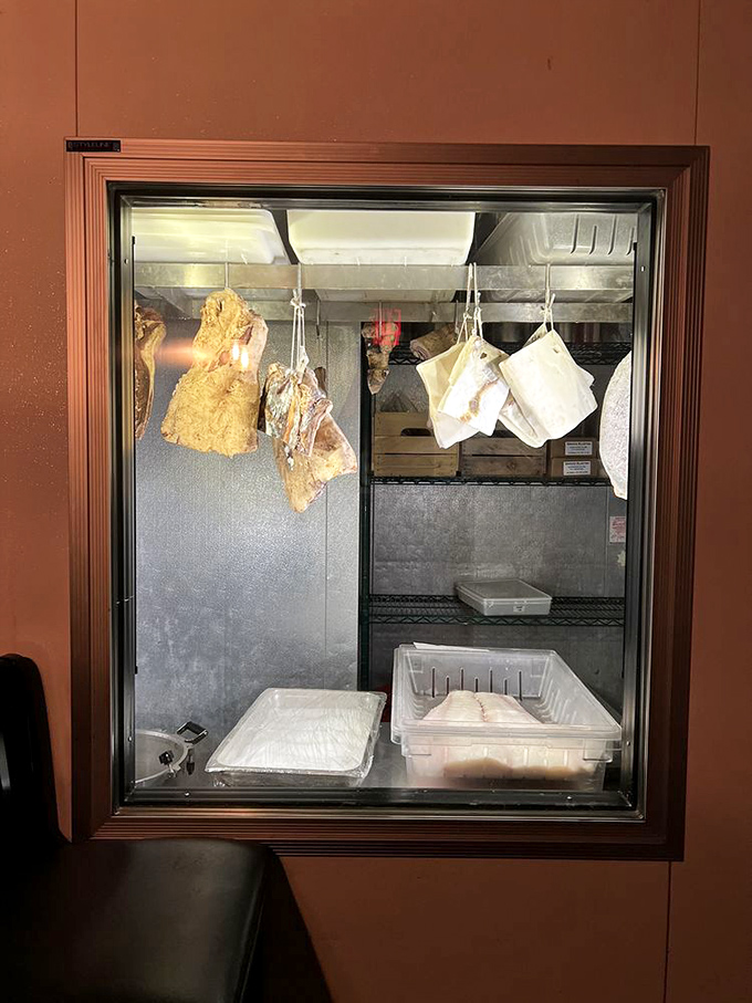 A glimpse into the meat cooler reveals the restaurant's commitment to proper aging and preparation – serious food for serious food lovers.