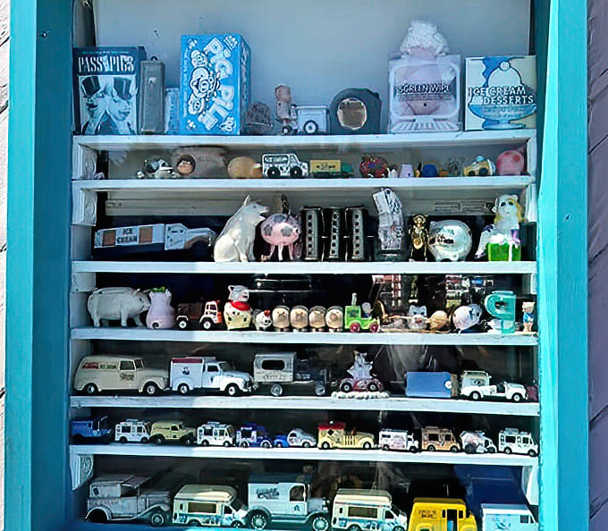 Miniature ice cream trucks line up like a parade of frozen dairy history, each tiny vehicle telling stories of desserts delivered in simpler times.