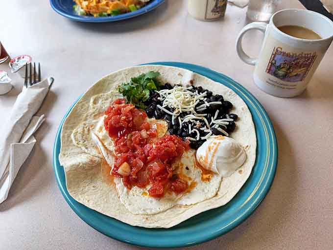 Breakfast goes south of the border with this tortilla treasure &ndash; eggs, black beans, and cheese creating a fiesta for your taste buds.