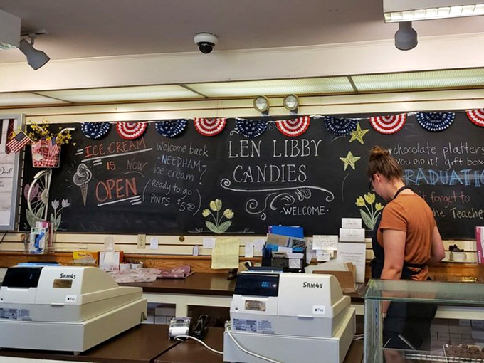 The register area features a sprawling chalkboard that tells the sweet story of Len Libby's offerings with artistic flair.