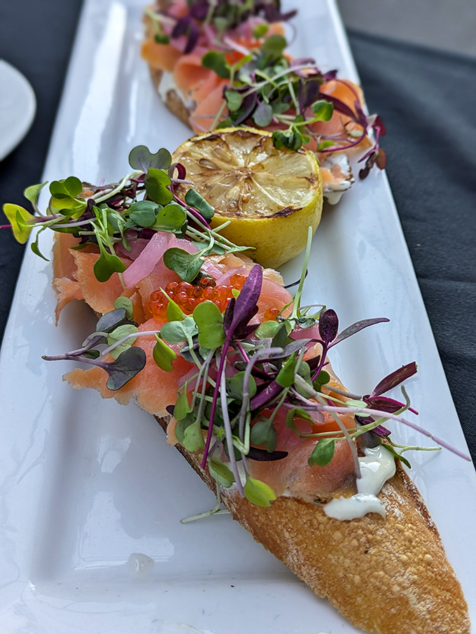 Salmon bruschetta elevated to art form – each bite delivers a perfect balance of creamy, crunchy, smoky, and fresh.
