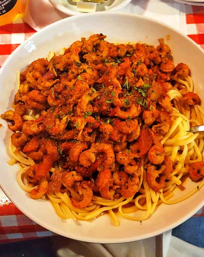 A mountain of perfectly cooked shrimp perched atop linguine &ndash; this seafood pasta doesn't just feed the body; it nourishes the soul with each garlicky bite.