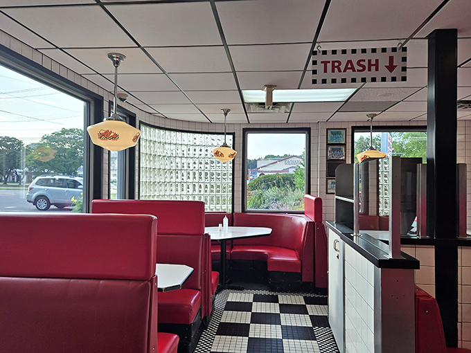 Checkered floors and red booths create the perfect backdrop for Al's timeless American dining experience.