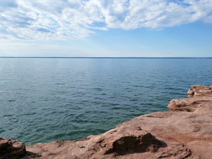 Rugged cliffs meet crystal-clear waters. It's like the Mediterranean decided to vacation in Wisconsin!