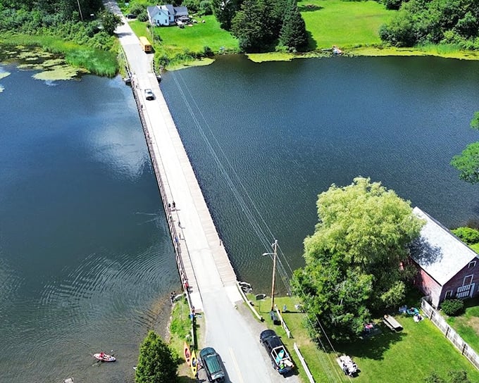 Birds-eye view reveals how the Floating Bridge cuts a straight path across Sunset Lake, connecting the community with elegant simplicity.