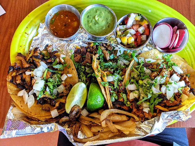 Traditional al pastor tacos served with all the fixings - a street food feast that brings Mexico City to Maine.