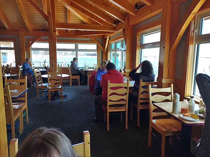 Diners enjoying their meals with lake views prove that the best restaurants understand location matters almost as much as the menu.