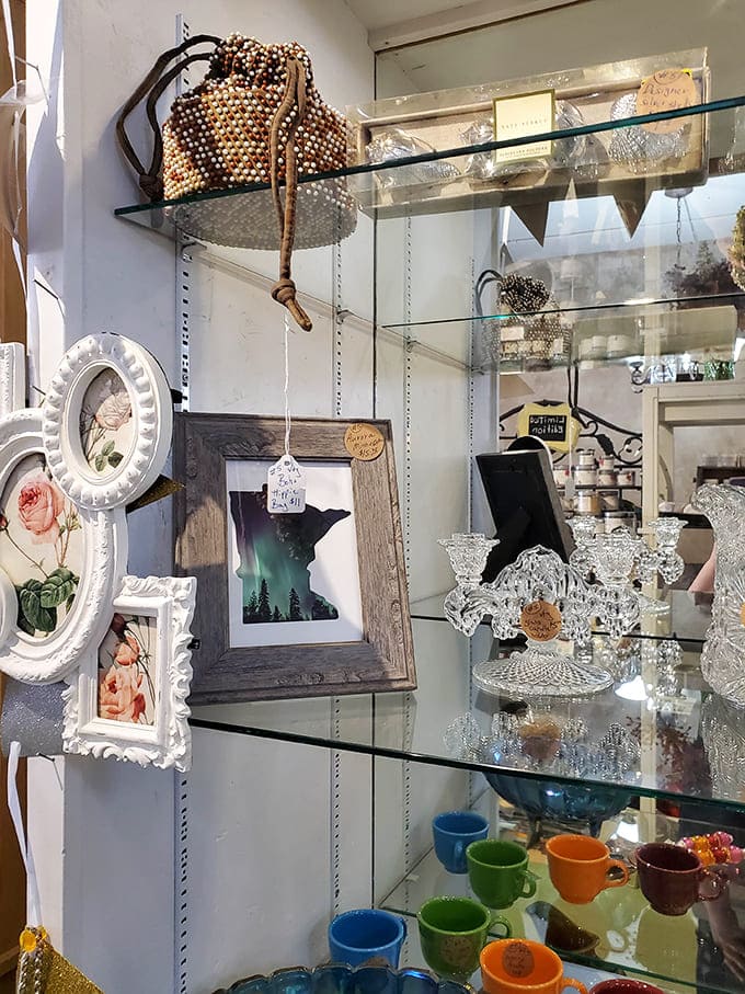 Shelves overflow with glassware and frames, each piece a small window into someone's past life and potentially your future decor scheme.