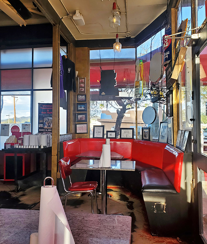 Red booths invite intimate conversations while vintage memorabilia on the walls silently narrates decades of American roadside history.