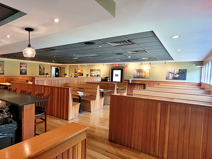 High-backed booths offer cozy nooks for intimate conversations, surrounded by the restaurant's signature wooden warmth and nautical charm.