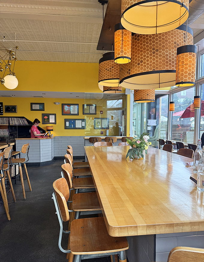 Yellow walls radiate warmth while the pressed tin ceiling adds vintage charm &ndash; a space that feels both thoroughly modern and comfortingly timeless.