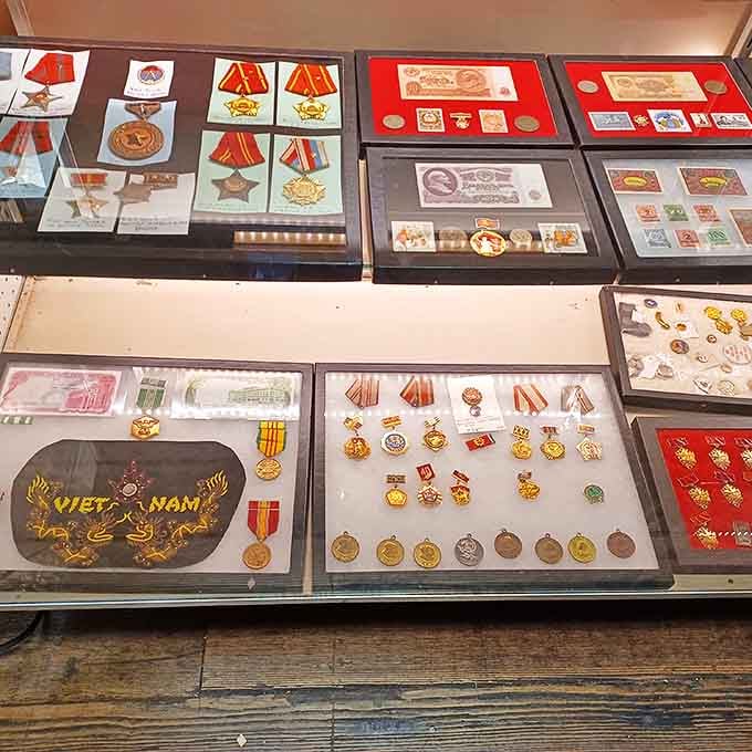 Military medals and historical currency displayed with reverence &ndash; silent witnesses to pivotal moments that shaped our world.