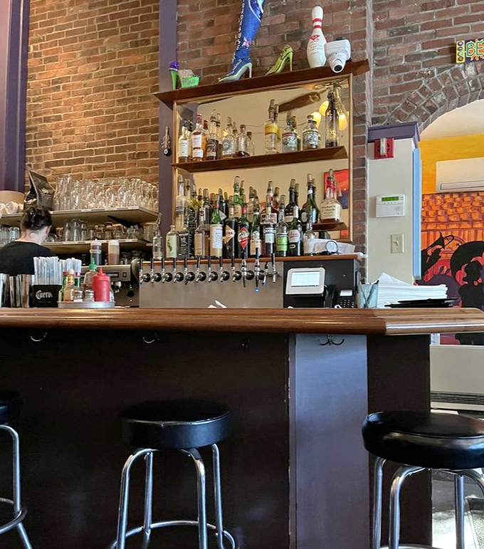 Bar: A well-stocked bar with bottles gleaming against exposed brick &ndash; where Southern hospitality meets Maine craftsmanship in liquid form.