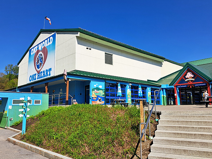 "One World, One Heart" adorns the factory exterior, showcasing the company's commitment to social causes alongside sweet treats.