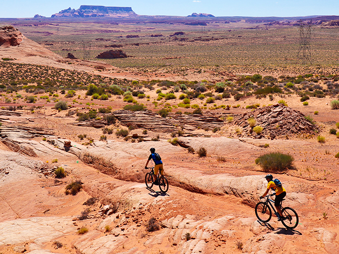 Desert warriors on two wheels: mountain bikers tackle Page's slickrock trails with stunning backdrops.