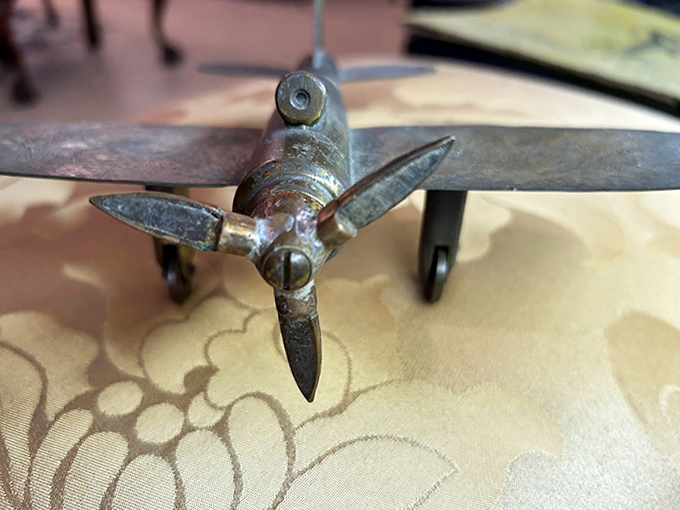 This miniature brass airplane model celebrates early aviation with the kind of detail craftsmanship modern toys have forgotten.