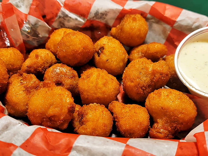 Golden-fried mushroom bites with their crispy exterior giving way to juicy centers—the perfect shareable starter that rarely makes it around the table twice.