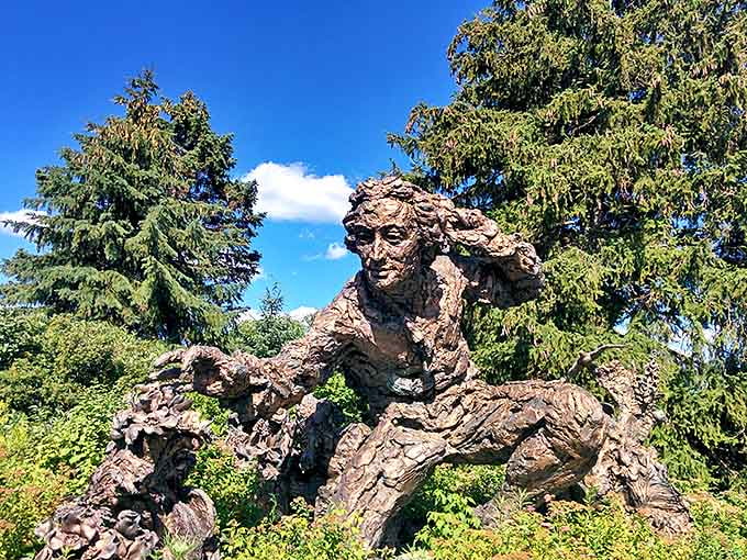 This bronze sculpture captures Carl Linnaeus mid-discovery, forever frozen in that moment of botanical revelation that changed scientific history.