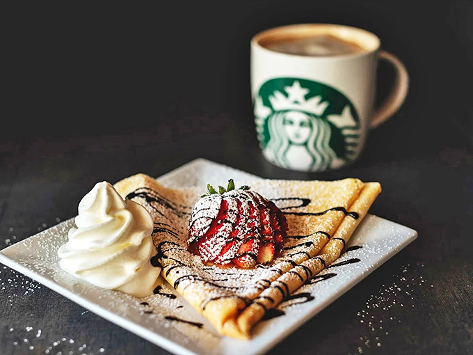 Sweet surrender on a plate &ndash; this crepe cradles fresh strawberries beneath a drizzle of chocolate and cloud of whipped cream.