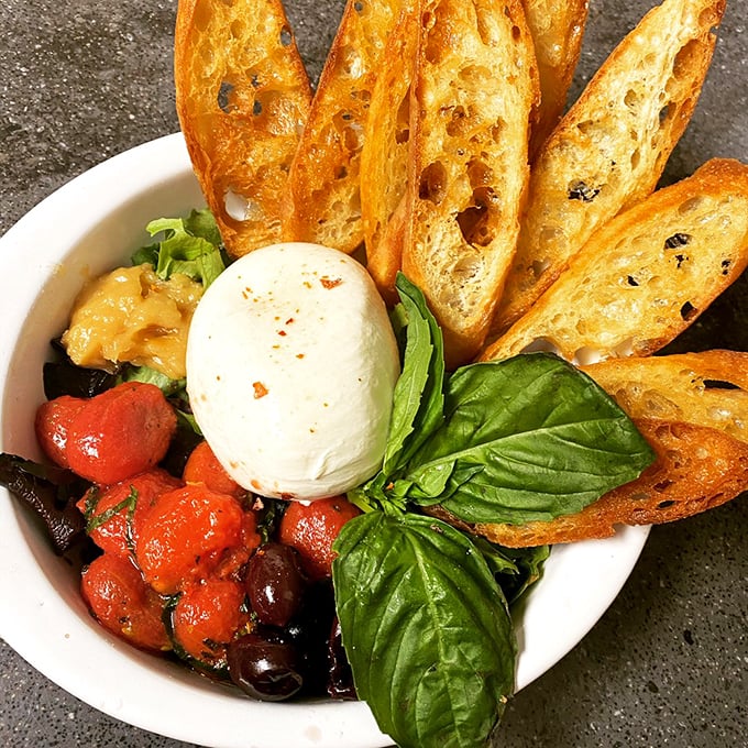 Cheese lovers, rejoice! This burrata plate is so fresh and creamy, it's like summer in Italy decided to vacation in Maine.