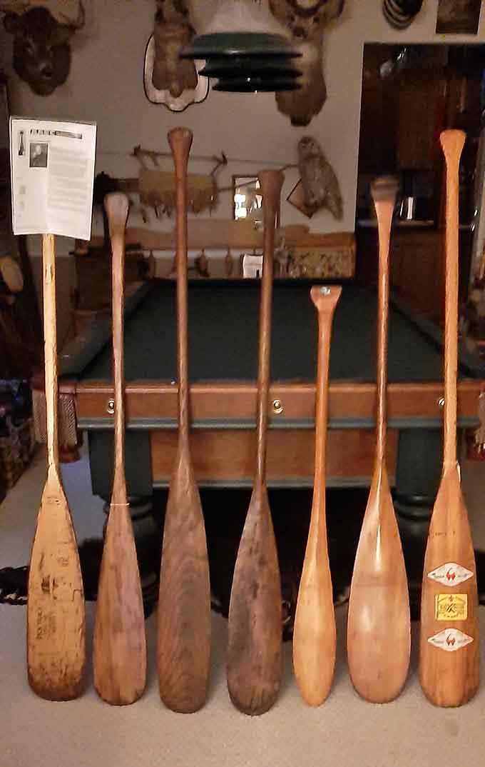 These wooden canoe paddles have propelled adventurers across northern waters, each blade worn smooth by lakes and rivers and determined arms.