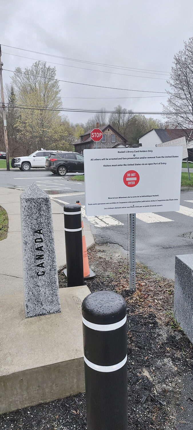 Canada Border Post: A stern warning in two languages reminds visitors of the serious business of borders, just steps from the library's more welcoming threshold.