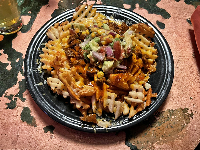 Waffle fries living their best life, smothered in carne asada and fresh toppings.
