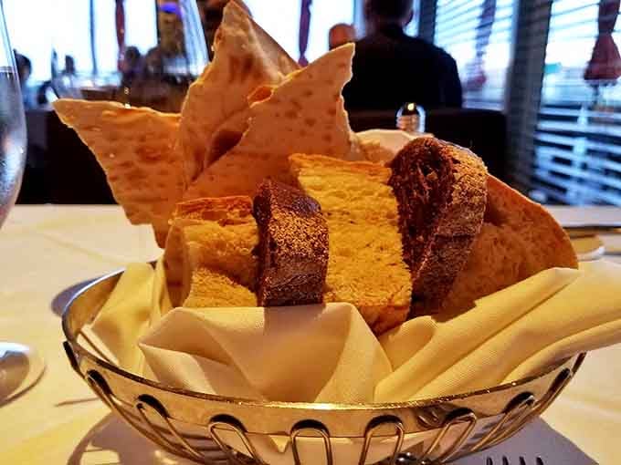 The bread basket that's worth saving room for &ndash; warm, crusty treasures nestled alongside delicate crackers, waiting for their butter moment.