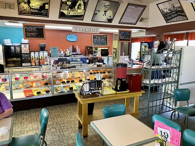 Counter area where dreams begin: Glass cases showcase tempting baked goods while friendly staff greet customers like old friends.