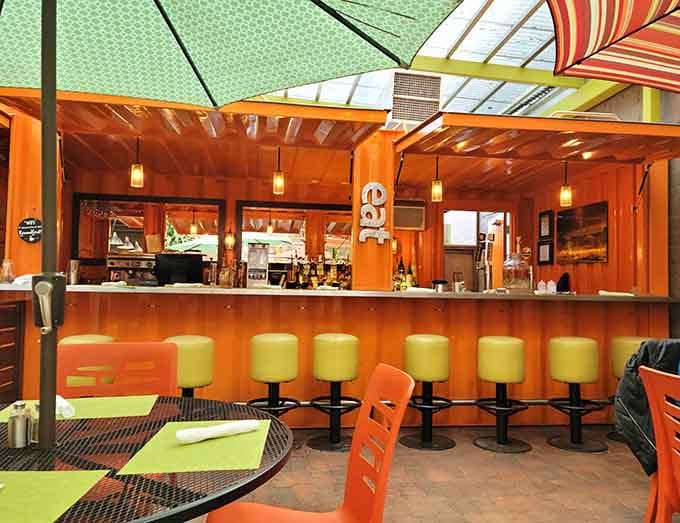 Those lime-green bar stools pop against the warm wood, creating a color combination that somehow works perfectly in this space.