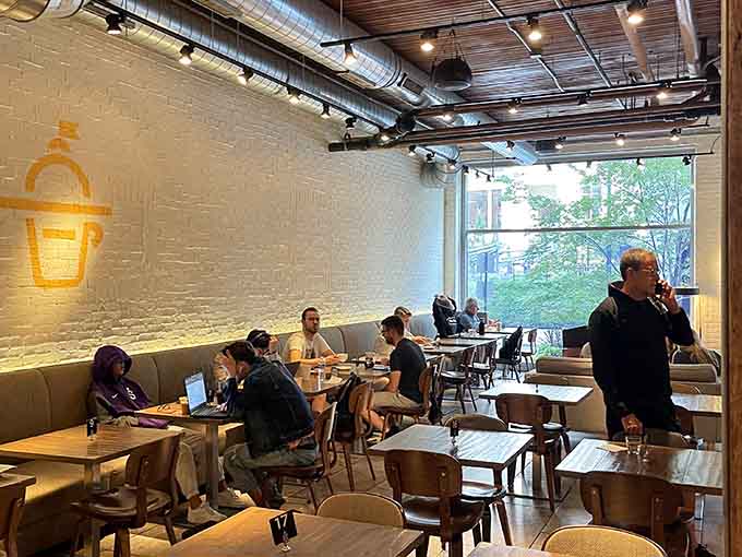 Another angle reveals the spacious layout perfect for laptop warriors, breakfast meetings, or simply enjoying your croissant sandwich in peaceful contemplation of its perfection.