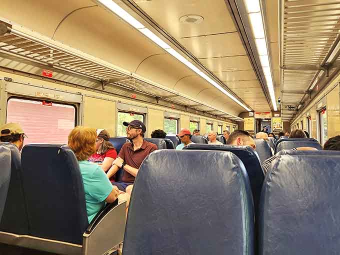 Passengers settle in for their scenic journey, each face showing that unique mix of relaxation and anticipation that only train travel inspires.