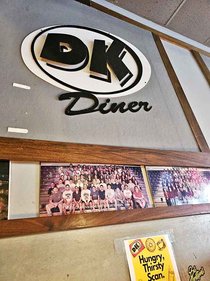 The iconic DK Diner sign watches over diners like a guardian angel of indulgent eating. Those class photos add a touch of community history.