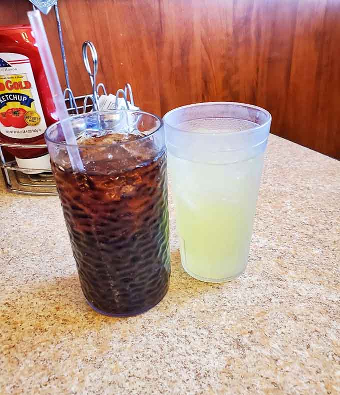 Beverages served in proper glasses because even the drinks get the full treatment at a place that respects the complete dining experience.