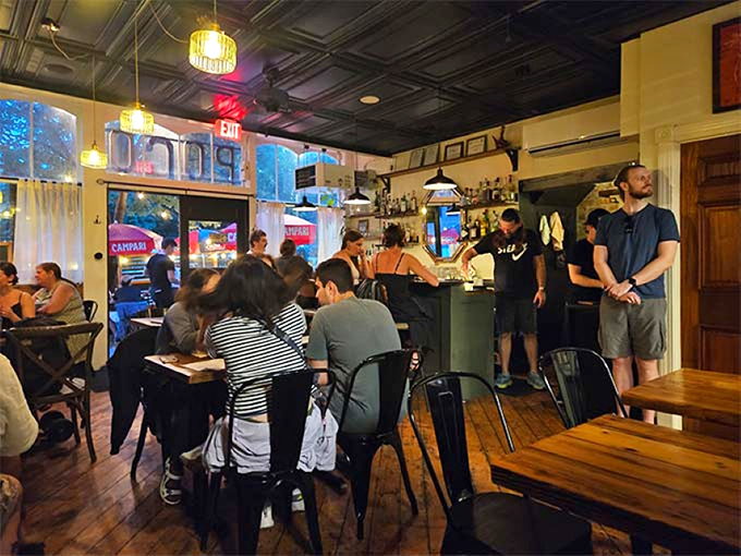 The dining room hums with the particular energy of people having genuinely good experiences, conversations flowing as freely as the wine.