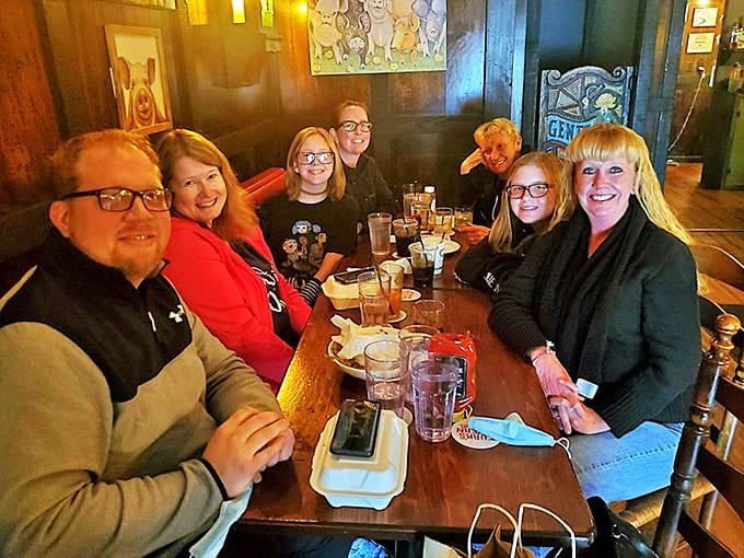 Happy diners gathered around the table, experiencing the genuine community atmosphere that makes Turk's more than just a restaurant.
