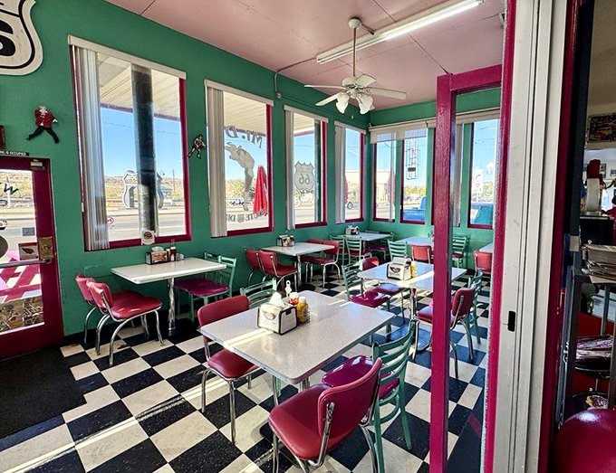 Mint green walls frame cherry-red booths in this dining area &ndash; a color combination that somehow makes everything taste better.