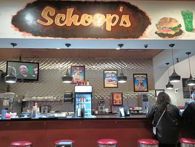 The counter seating offers prime viewing of the kitchen action, where skilled cooks flip burgers and assemble orders with practiced precision.