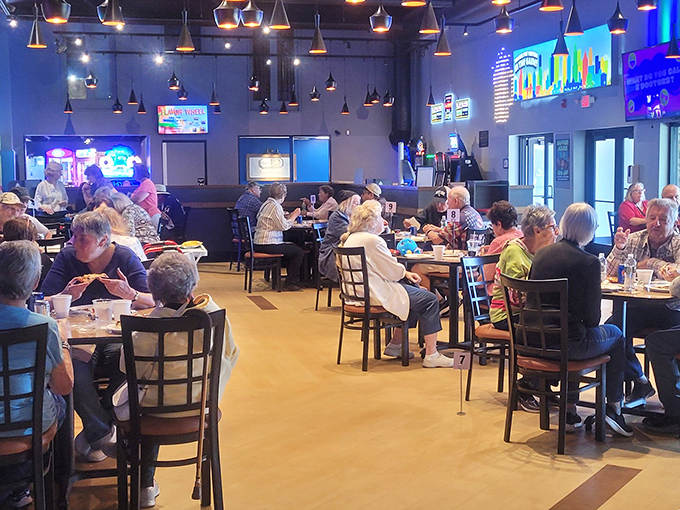 Hungry adventurers refuel in the modern dining space, where conversations about high scores mix with the clinking of glasses.