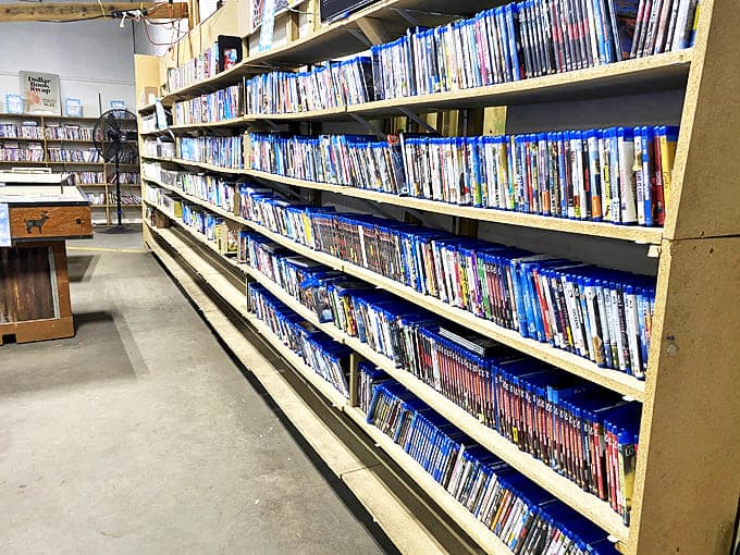 A cinephile's dream &ndash; rows of DVDs offer visual storytelling alongside their written counterparts. The blue cases create their own visual rhythm.