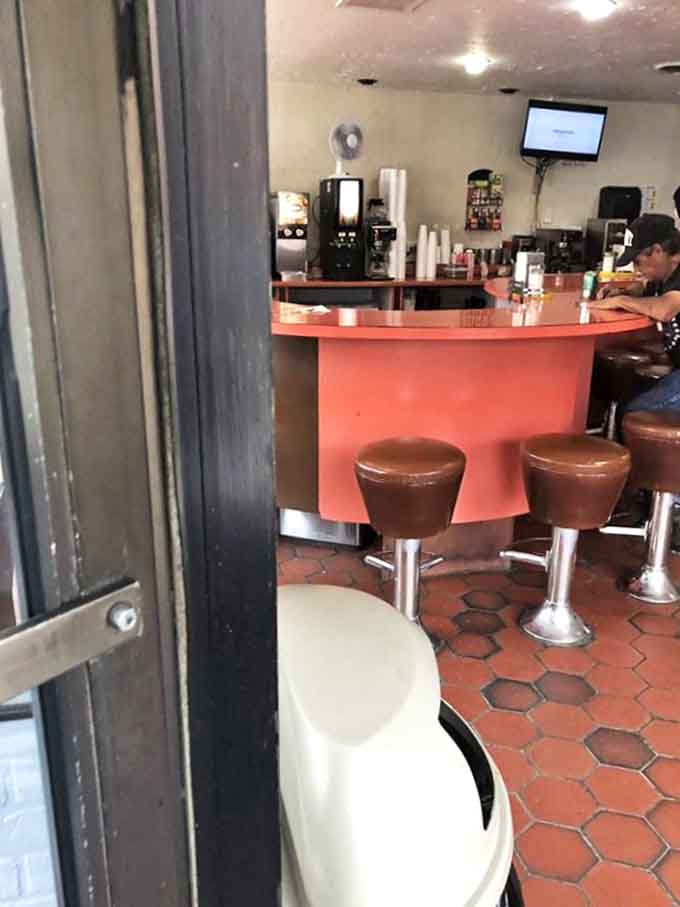 That eye-catching curved table design isn't just for show, it creates an inviting space where strangers become friends over shared appreciation for great pastries.