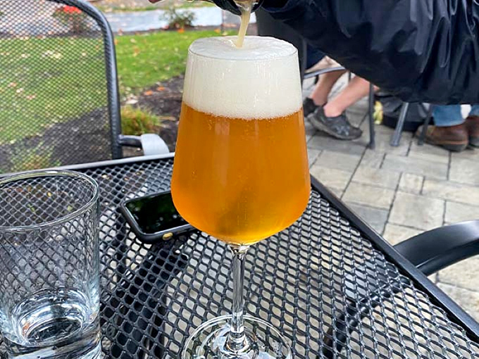 Liquid gold captured in elegant glassware. Vermont's craft brewing excellence, perfectly poured with a photogenic head.