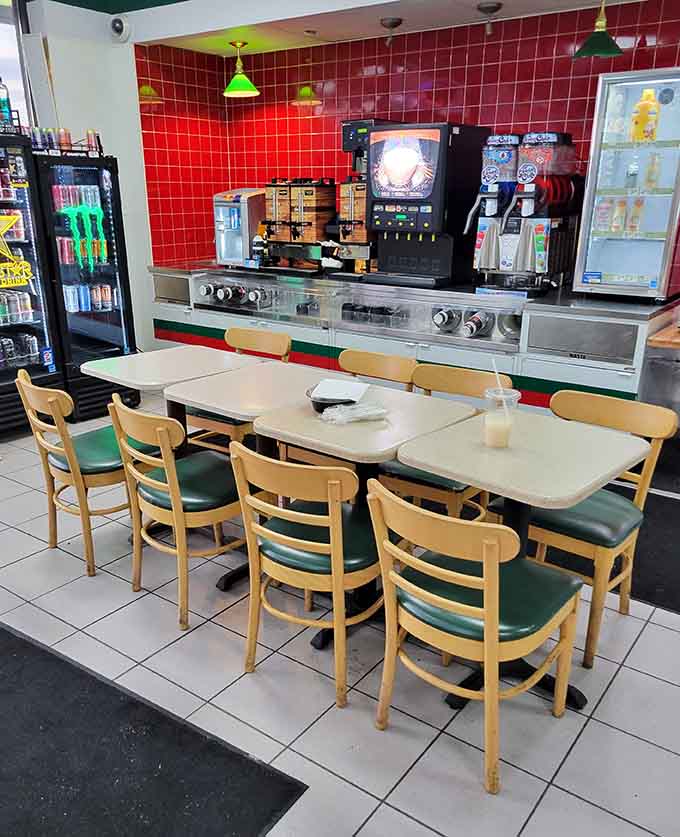 The dining area offers simple but comfortable seating with a view of the kitchen, where you can watch your meal being prepared fresh.