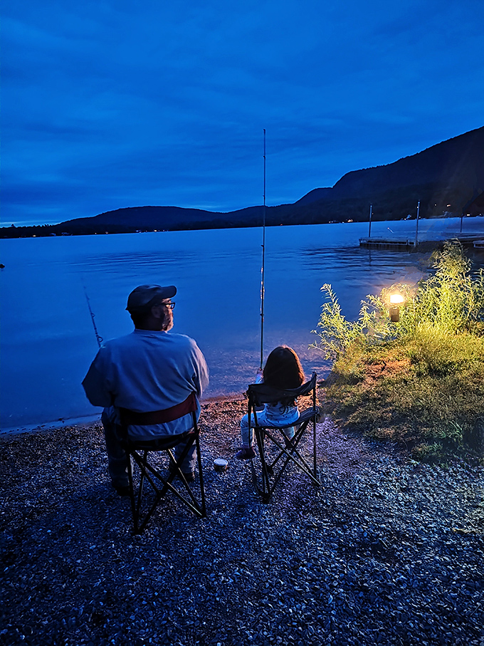 As twilight settles over Lake Dunmore, fishing becomes a magical experience shared between generations under the watchful mountains.