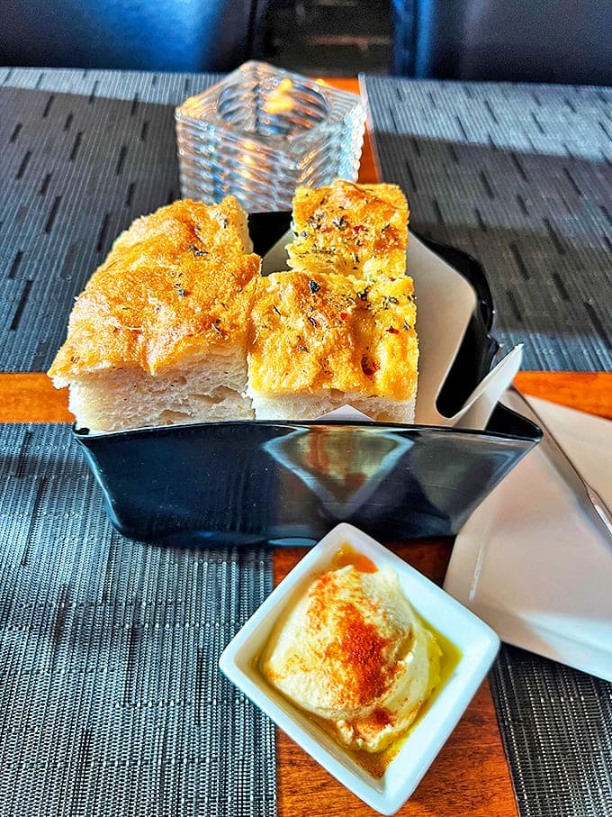 Focaccia that deserves its own Instagram account. Warm, olive oil-kissed bread that makes you question your carb-avoiding life choices.